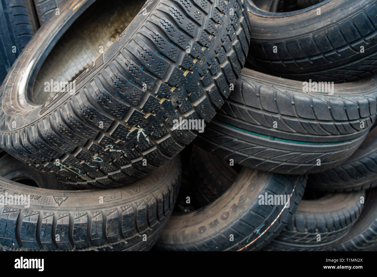 Random pile of used car tyres piled up for resale in a distribution ...