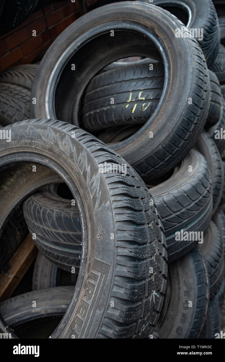 Random pile of used car tyres piled up for resale in a distribution ...