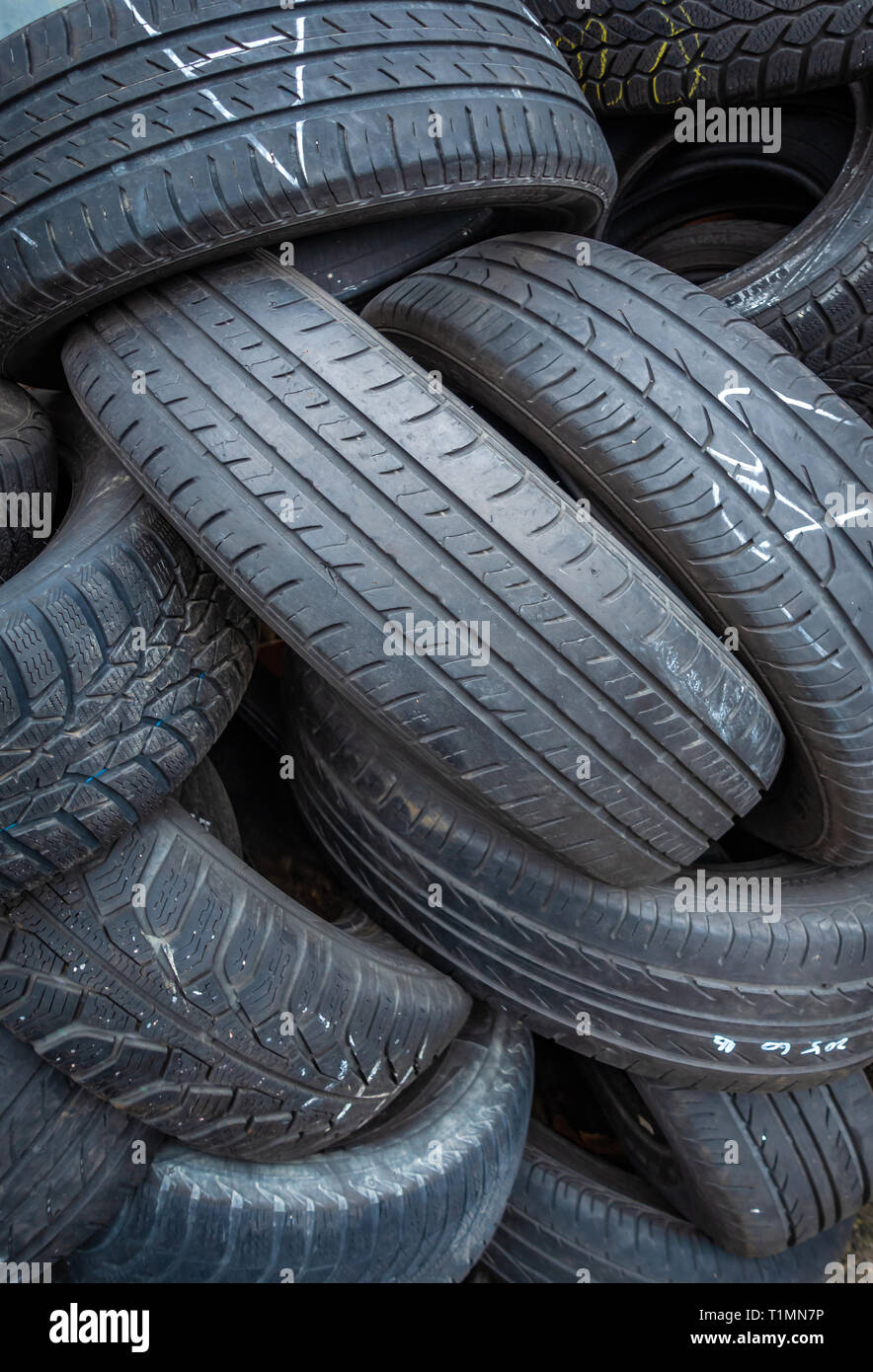 Random pile of used car tyres piled up for resale in a distribution ...
