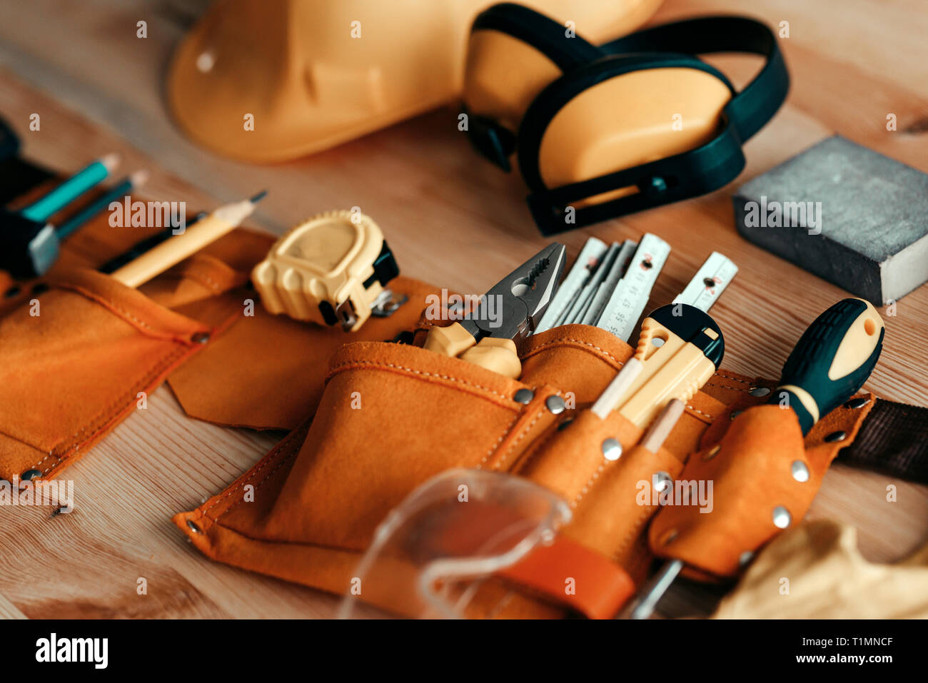 Carpentry tools and protective equipment on the desk in woodwork ...