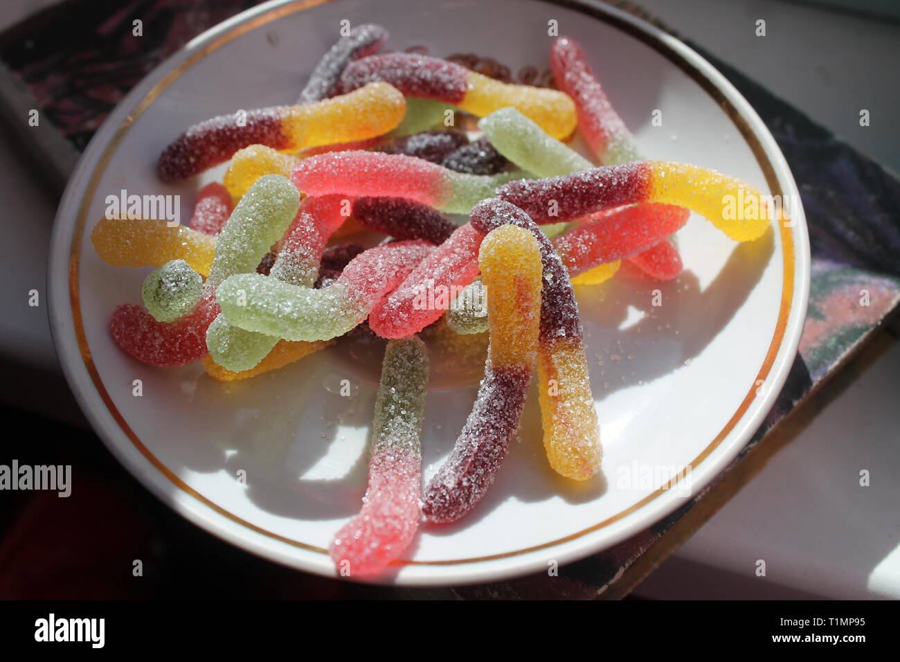 sweet jelly colorful candy in shape of worms on plate for dessert Stock ...