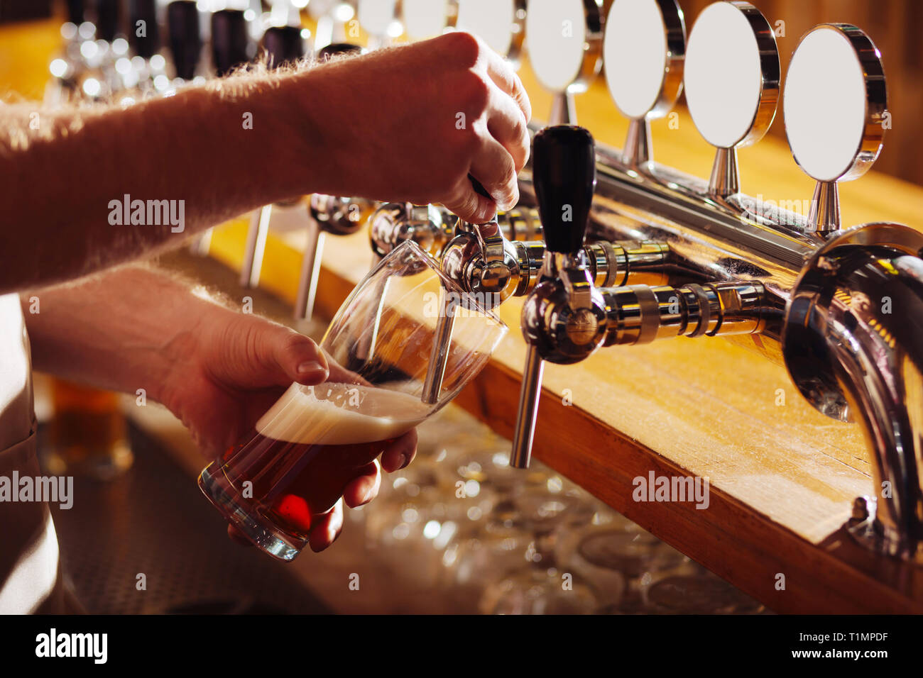 Barman pouring ale hi-res stock photography and images - Alamy