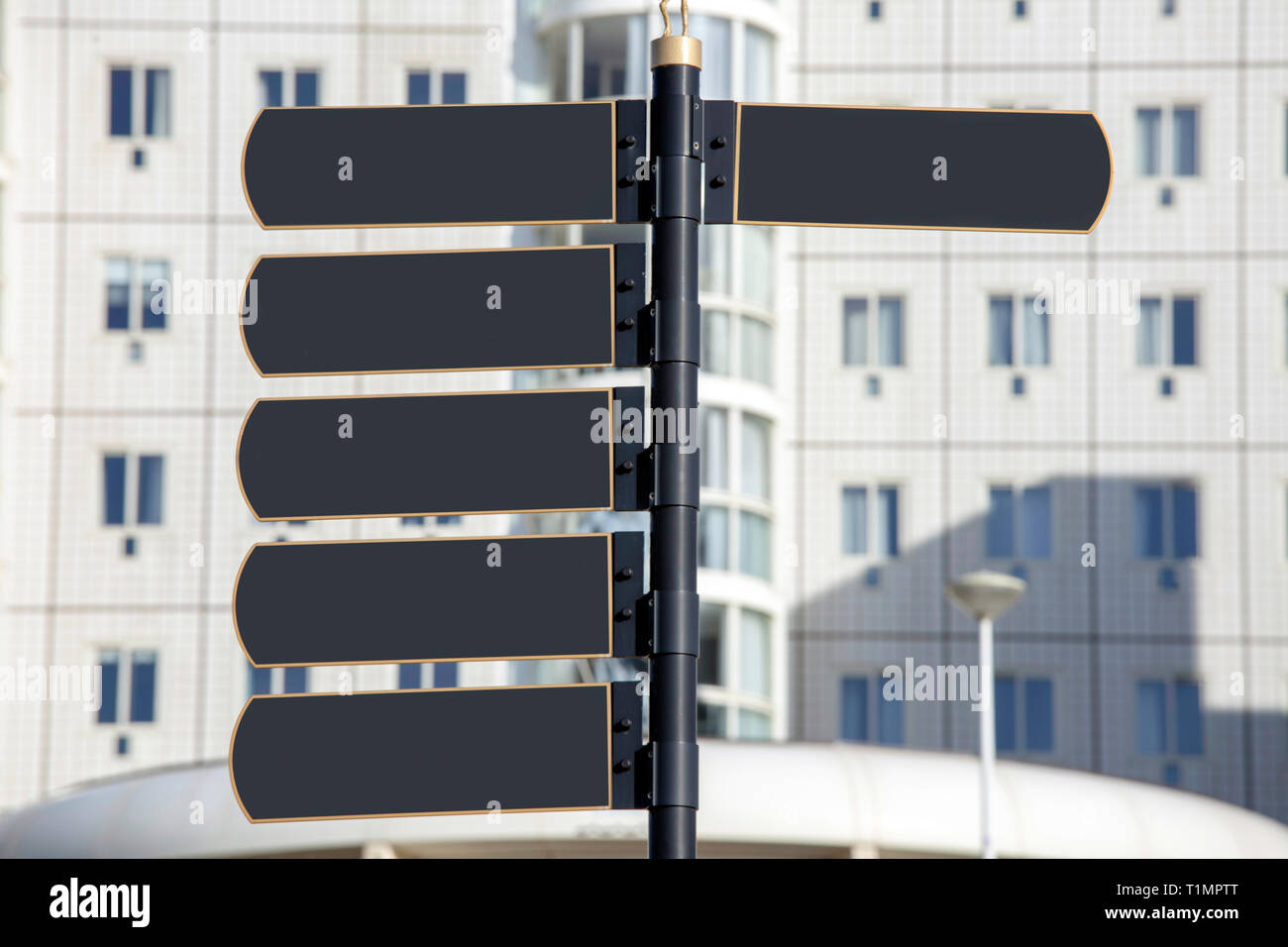 Empty dark metal pointers on the background of white house with windows ...