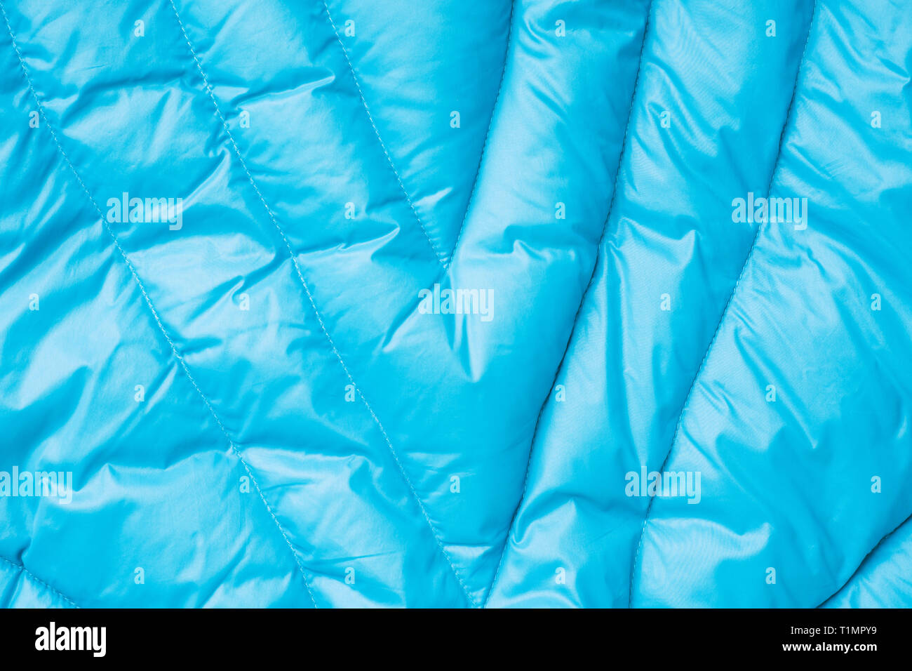Close-up on blue puffer jacket texture. Background of quilted material ...