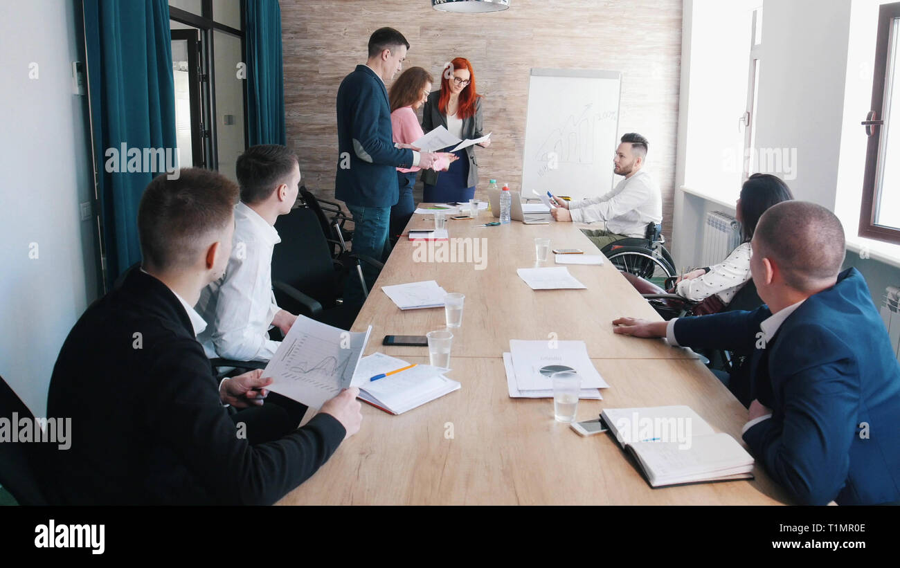 A business conference. People checking the report Stock Photo - Alamy