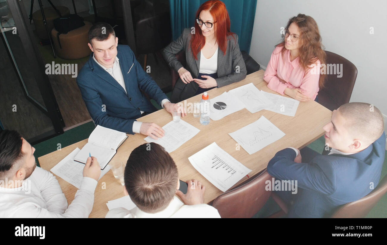 Successful people at the business conference talking by the table Stock ...