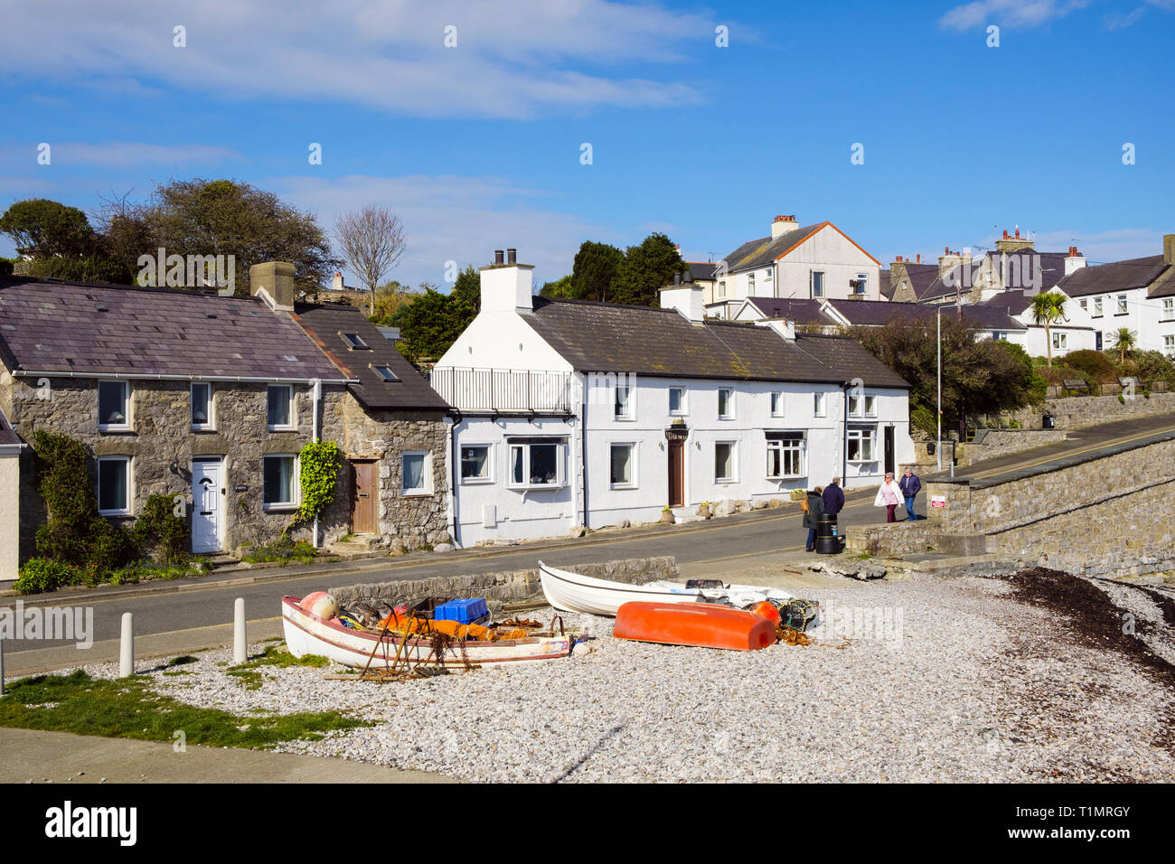 View to cottages on waterfront with fishing boats on beach in village ...