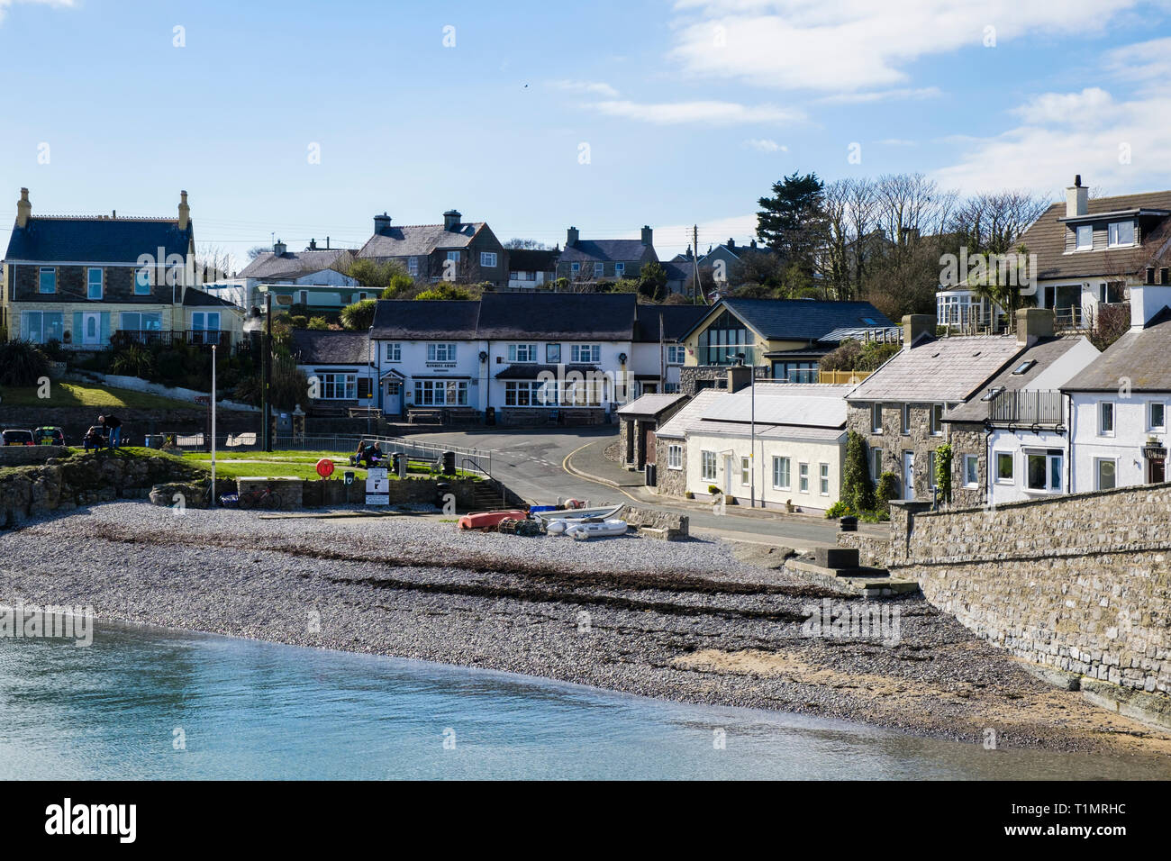 View across beach to cottages and pub on waterfront in village of ...