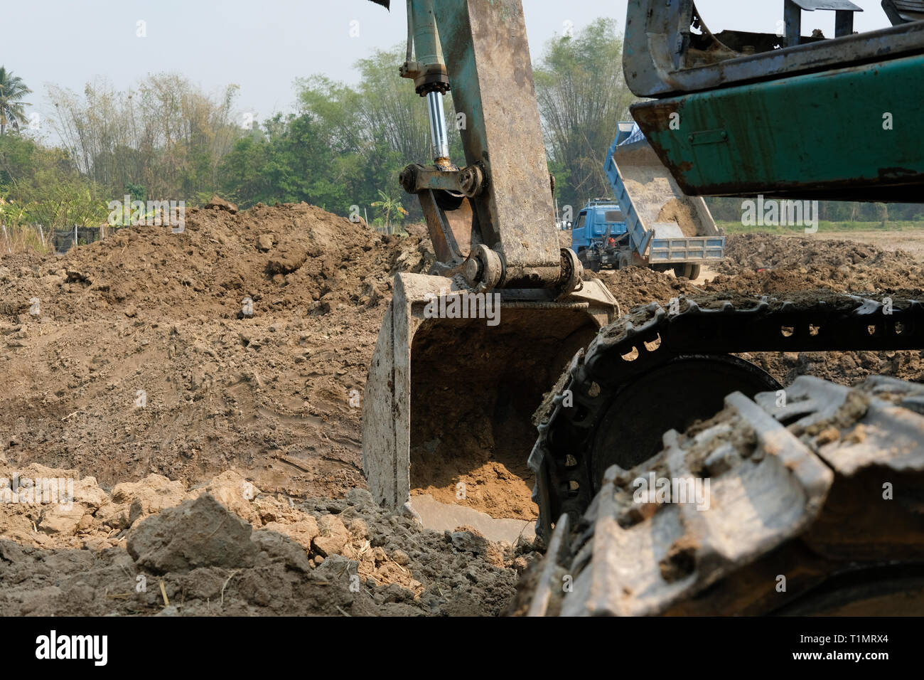 excavator digging making pond. earthmoving work in farmland Stock Photo ...