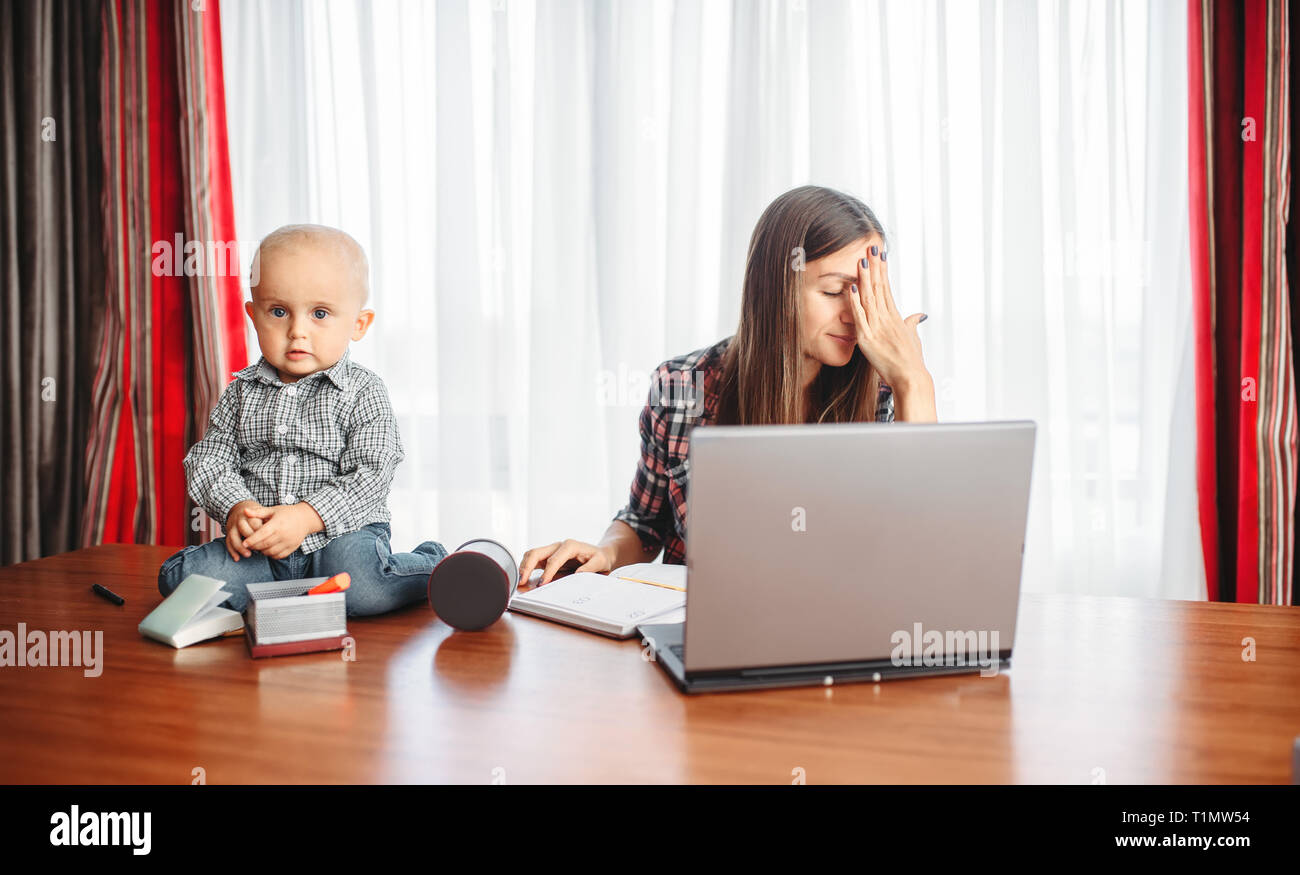 Mother works, kid helps her, motherhood problems Stock Photo - Alamy