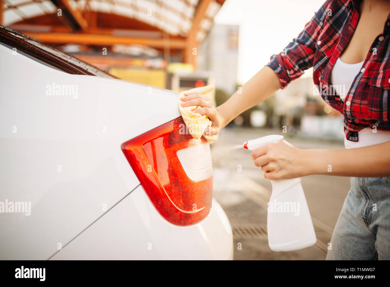 Woman cleans rear lights car hi-res stock photography and images - Alamy