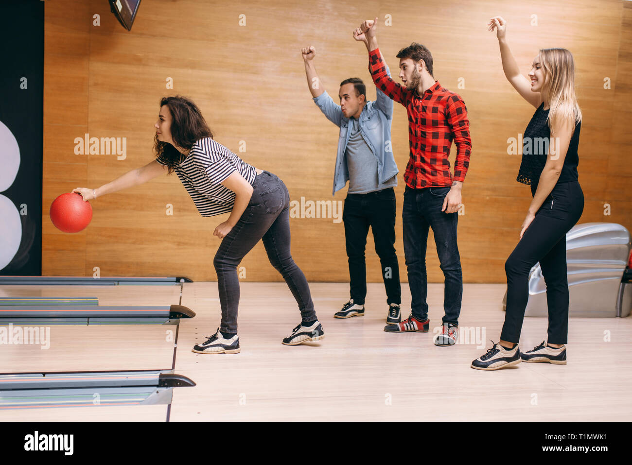 Female bowler on lane, ball throwing in action Stock Photo - Alamy