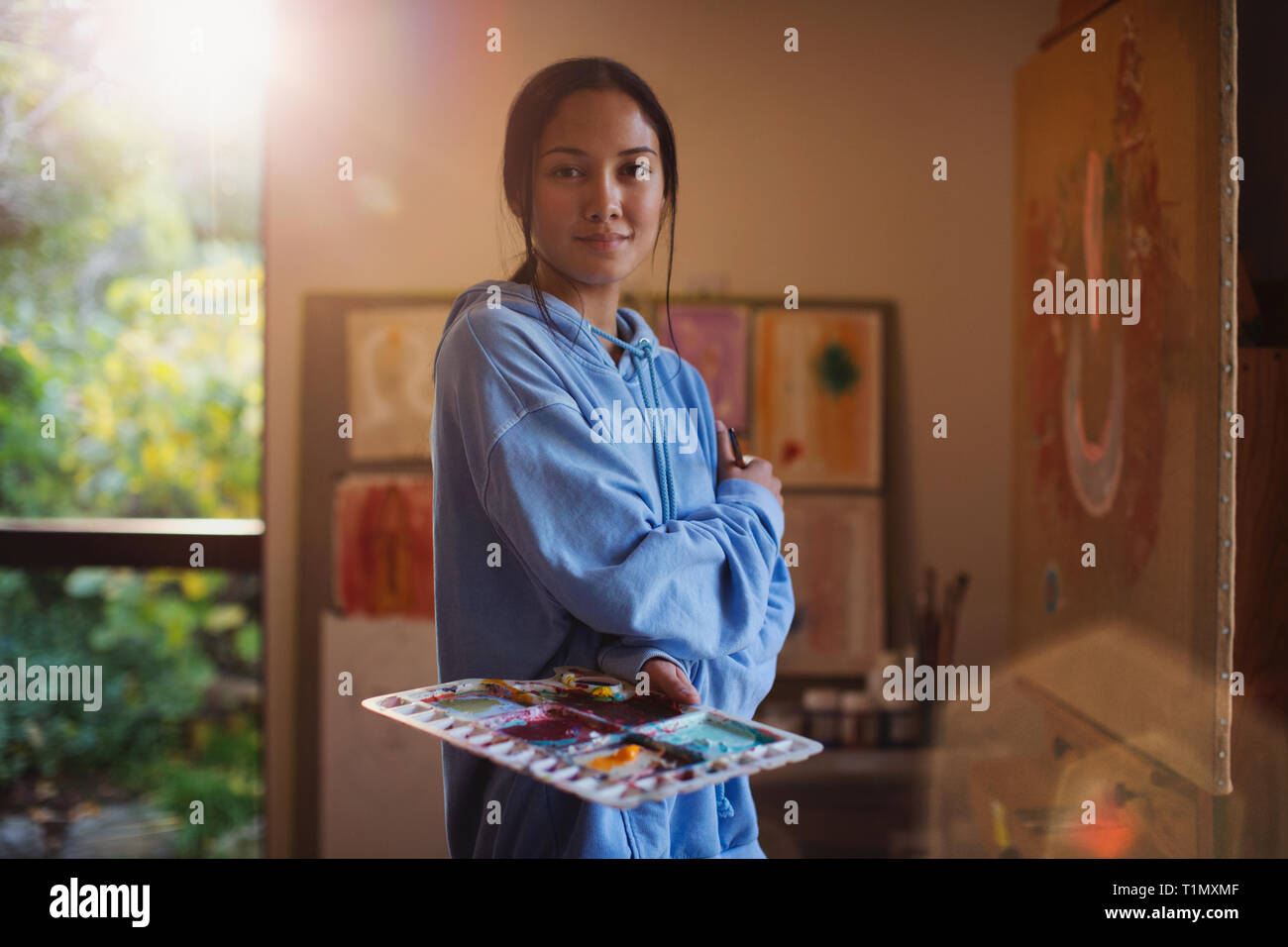 Portrait confident female artist painting in art studio Stock Photo - Alamy