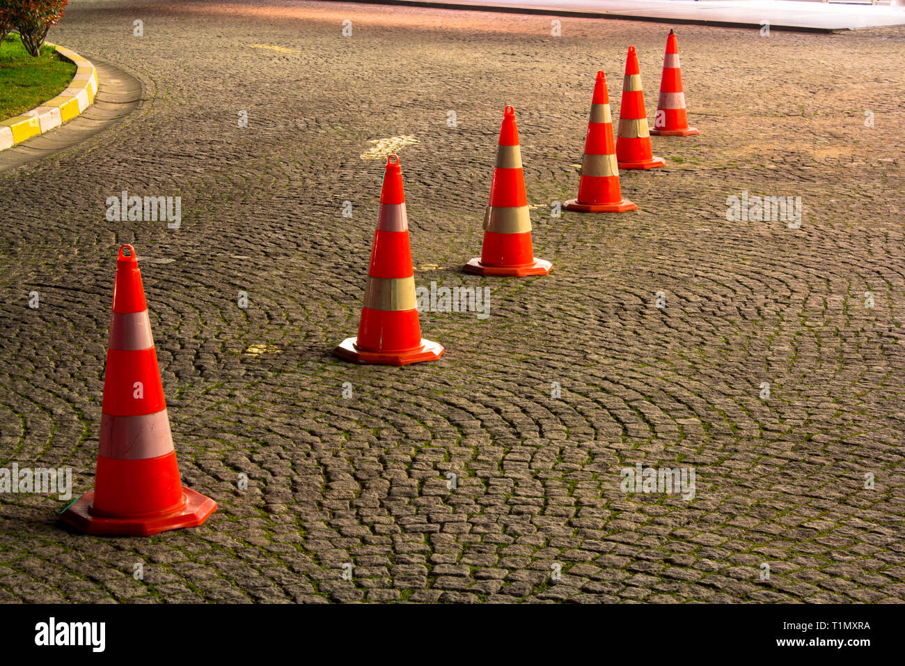 Road cones on the pavement before entering somewhere. Night street ...