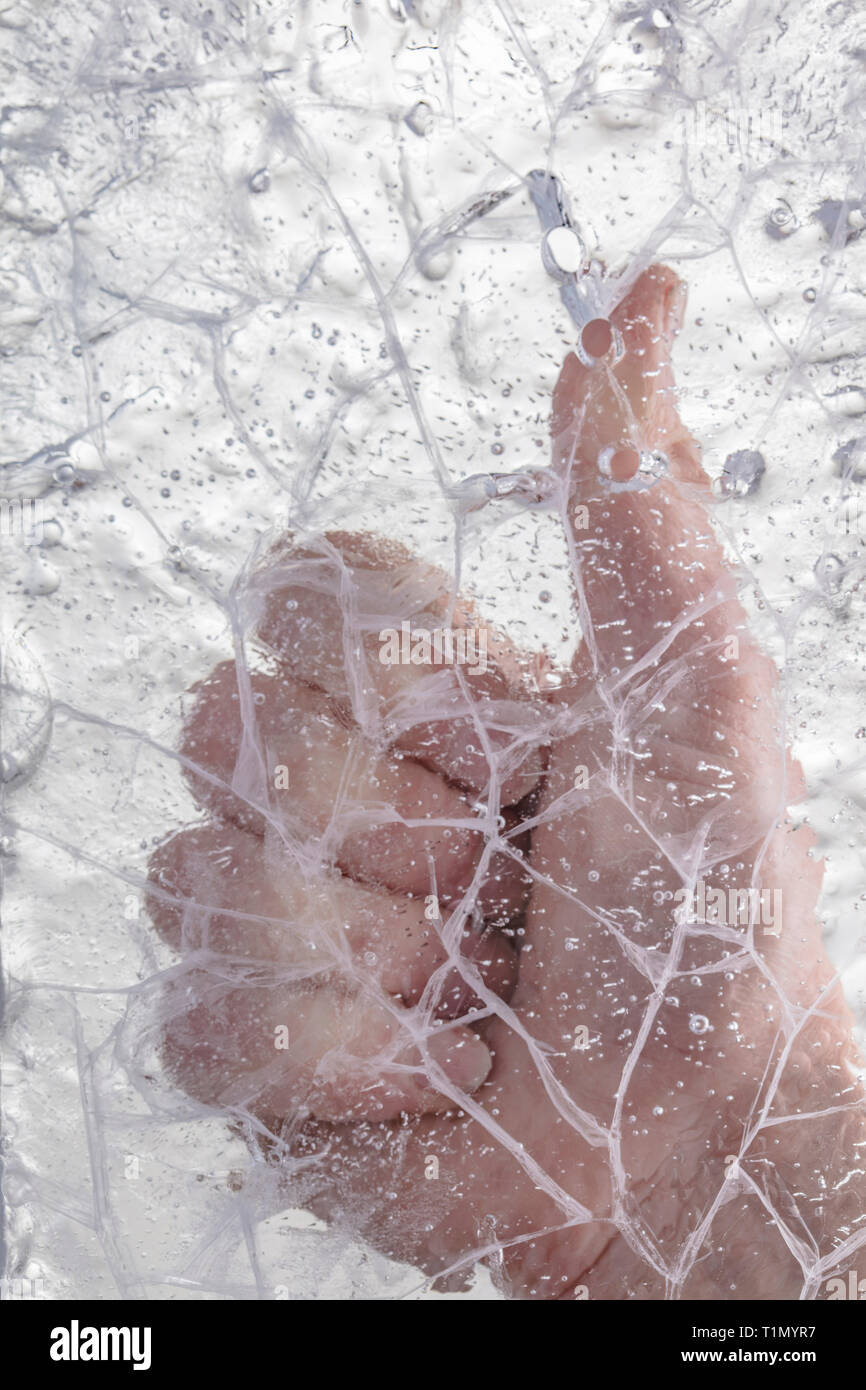 Hand with positive gesture in a block of cracked ice. Positivity ...