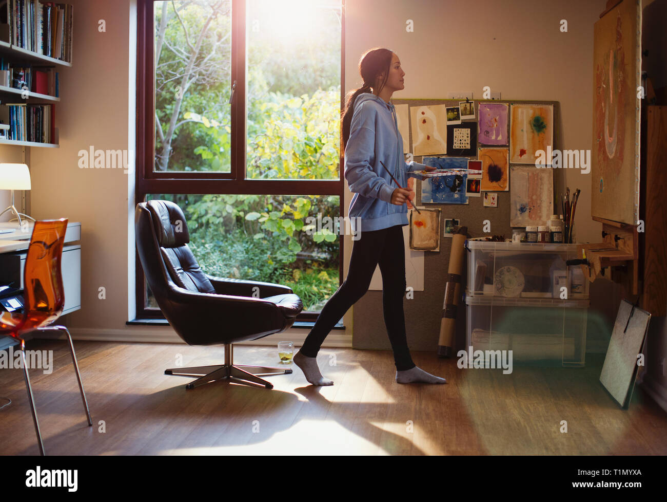 Female artist painting in home office Stock Photo - Alamy