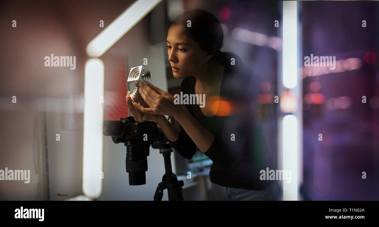 Female photographer looking at prototype Stock Photo - Alamy