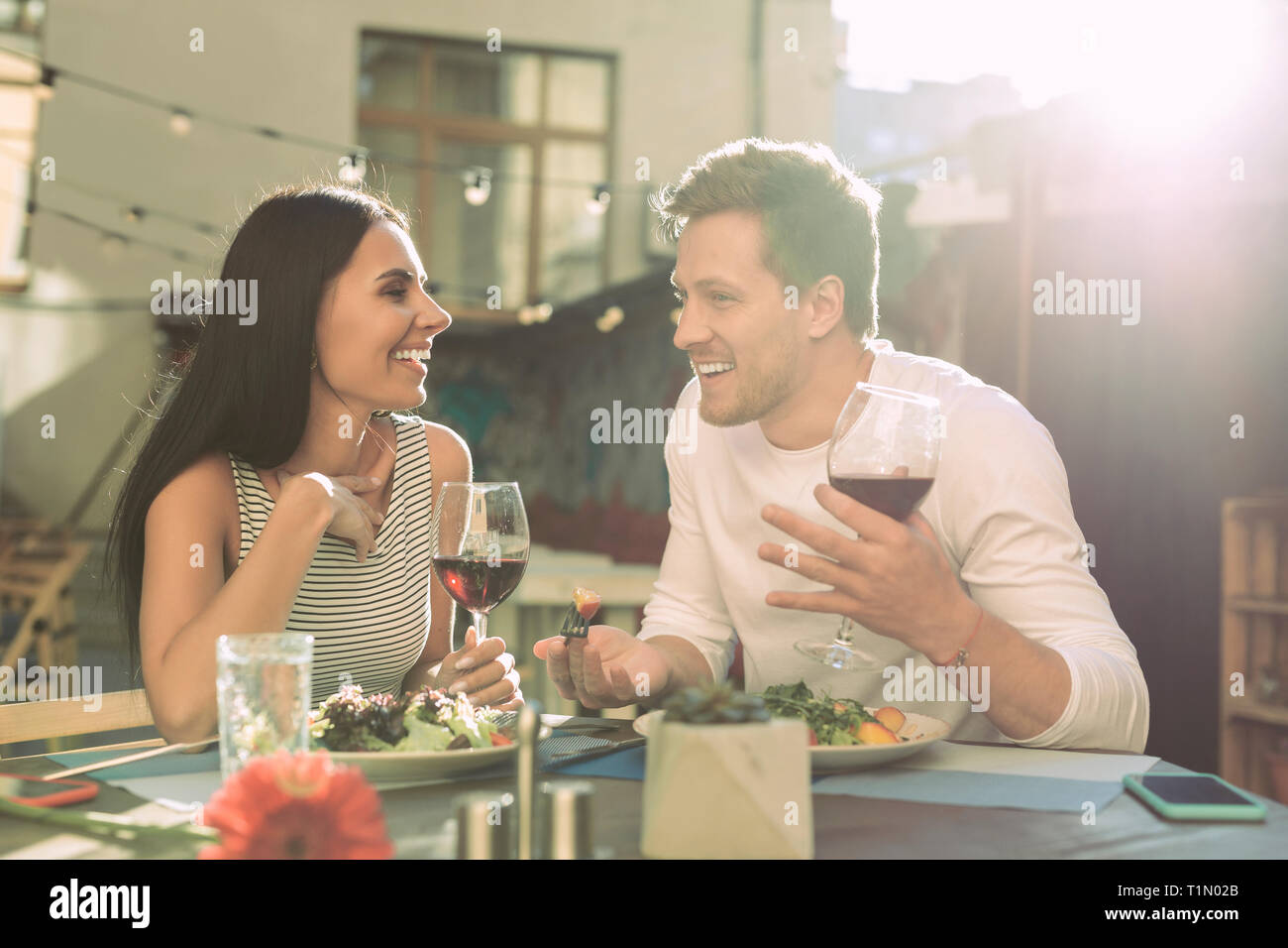 Positive good-looking couple having active conversation while laughing ...