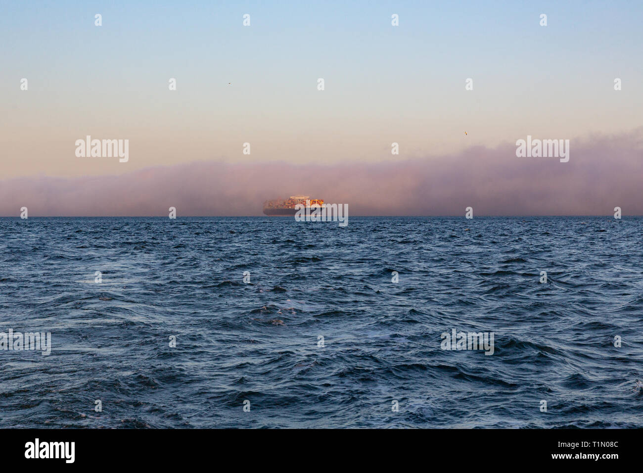 Loaded container ship emerges from fog into bright sunshine in San ...