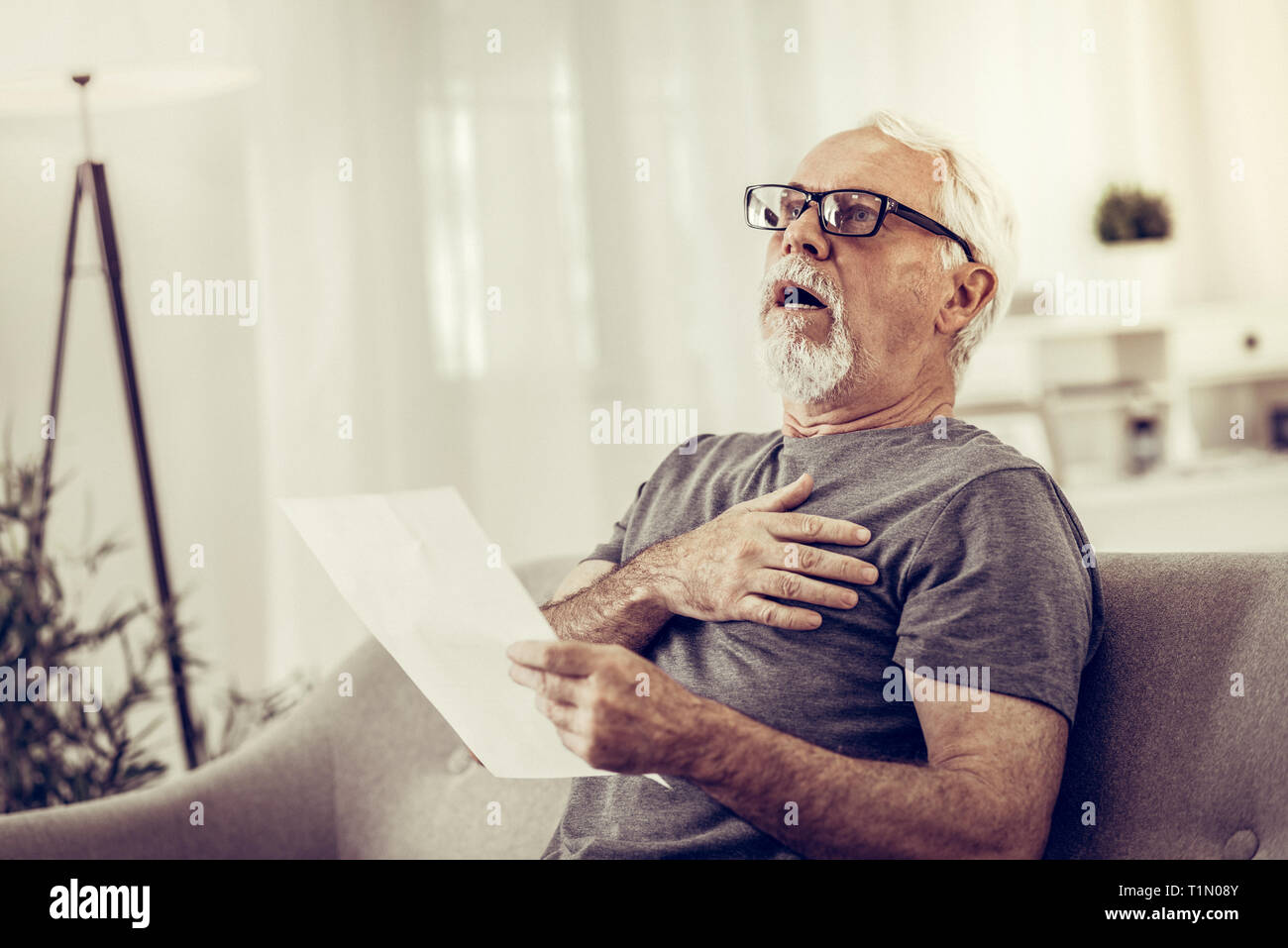 Shocked man having a heart attack after reading of papers Stock Photo ...