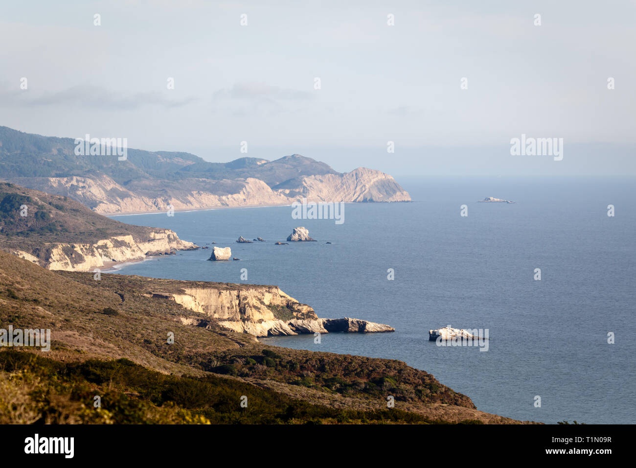Mountain top view of California coast cliffs and coves on a bright ...