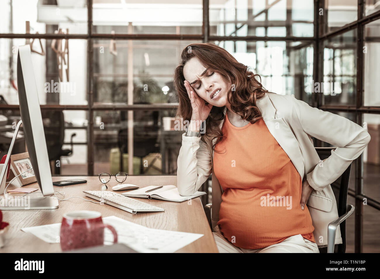 Woman supporting her back hi-res stock photography and images - Alamy