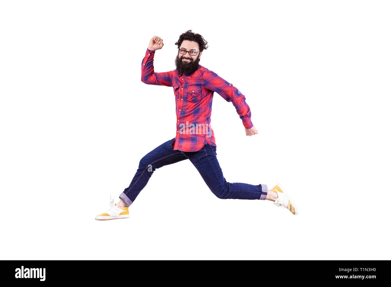 Full length portrait of running and jumping bearded hipster, happy ...