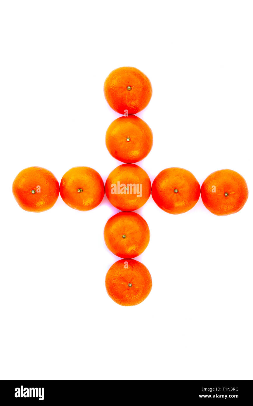 Plus shape solved with tangerines isolated on white background Stock ...