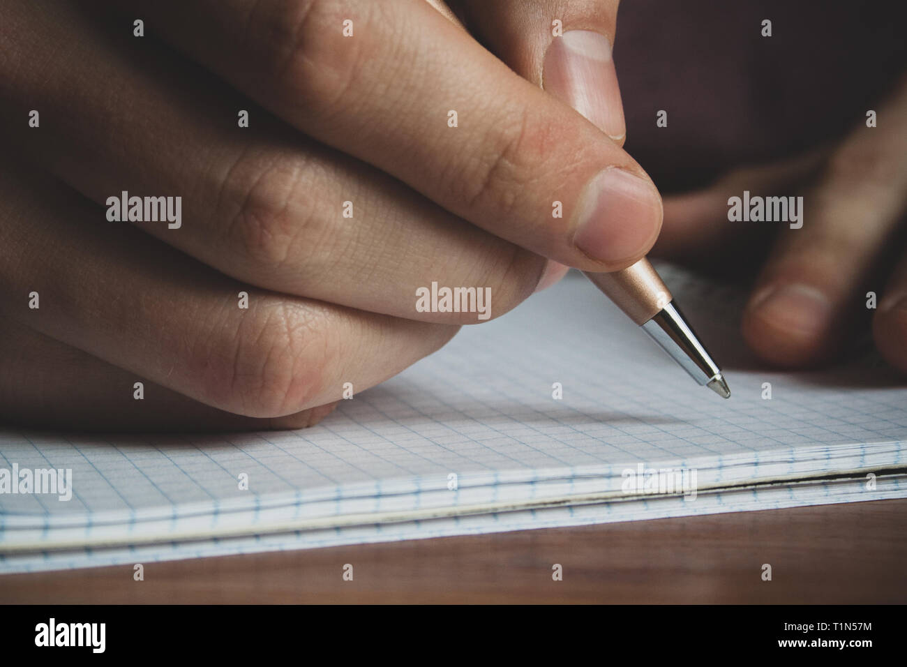 Man writes in notebook sitting hi-res stock photography and images - Alamy