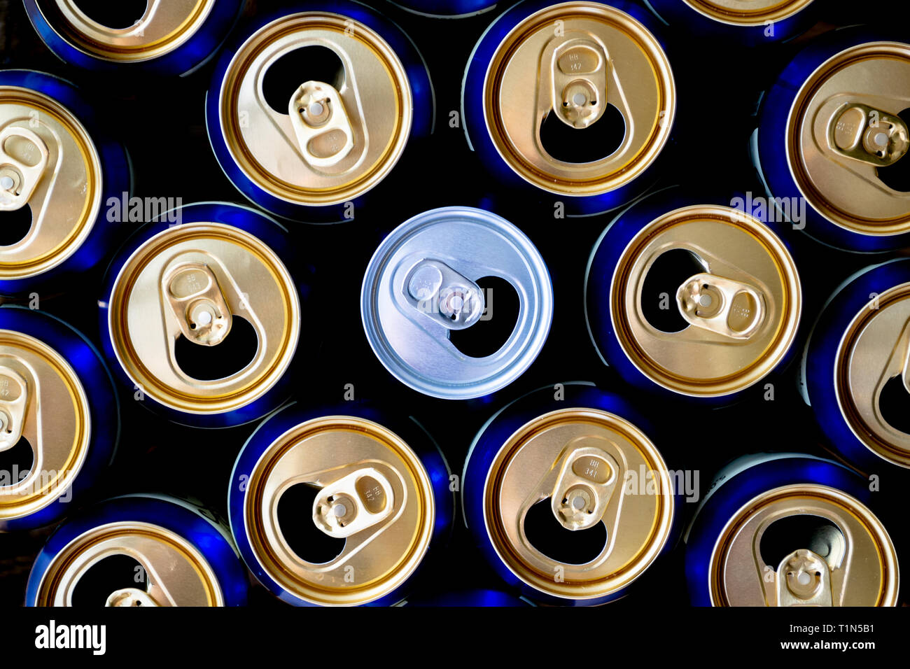 Abstract pattern of opened aluminium cans, top view. One white soda or ...
