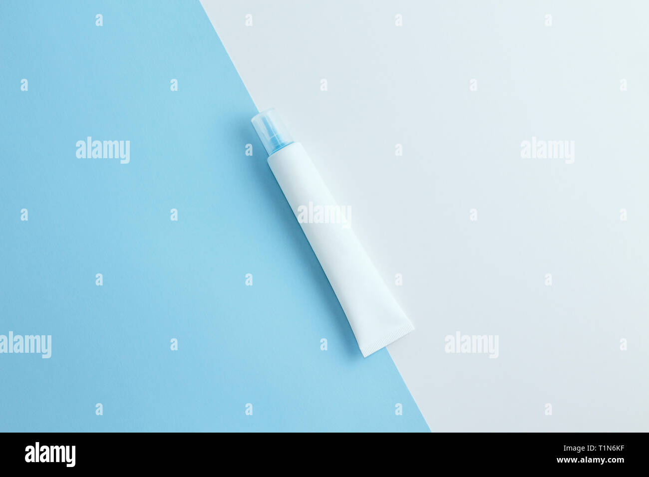 Cosmetics tube on light blue and white background. Copy space. Flat lay ...