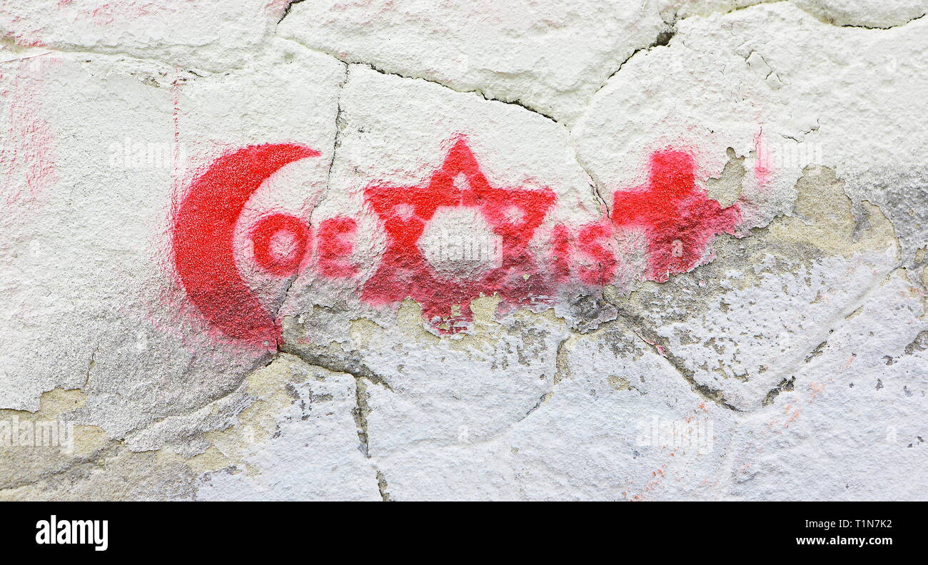 Graffiti wall with red text COEXIST Stock Photo - Alamy