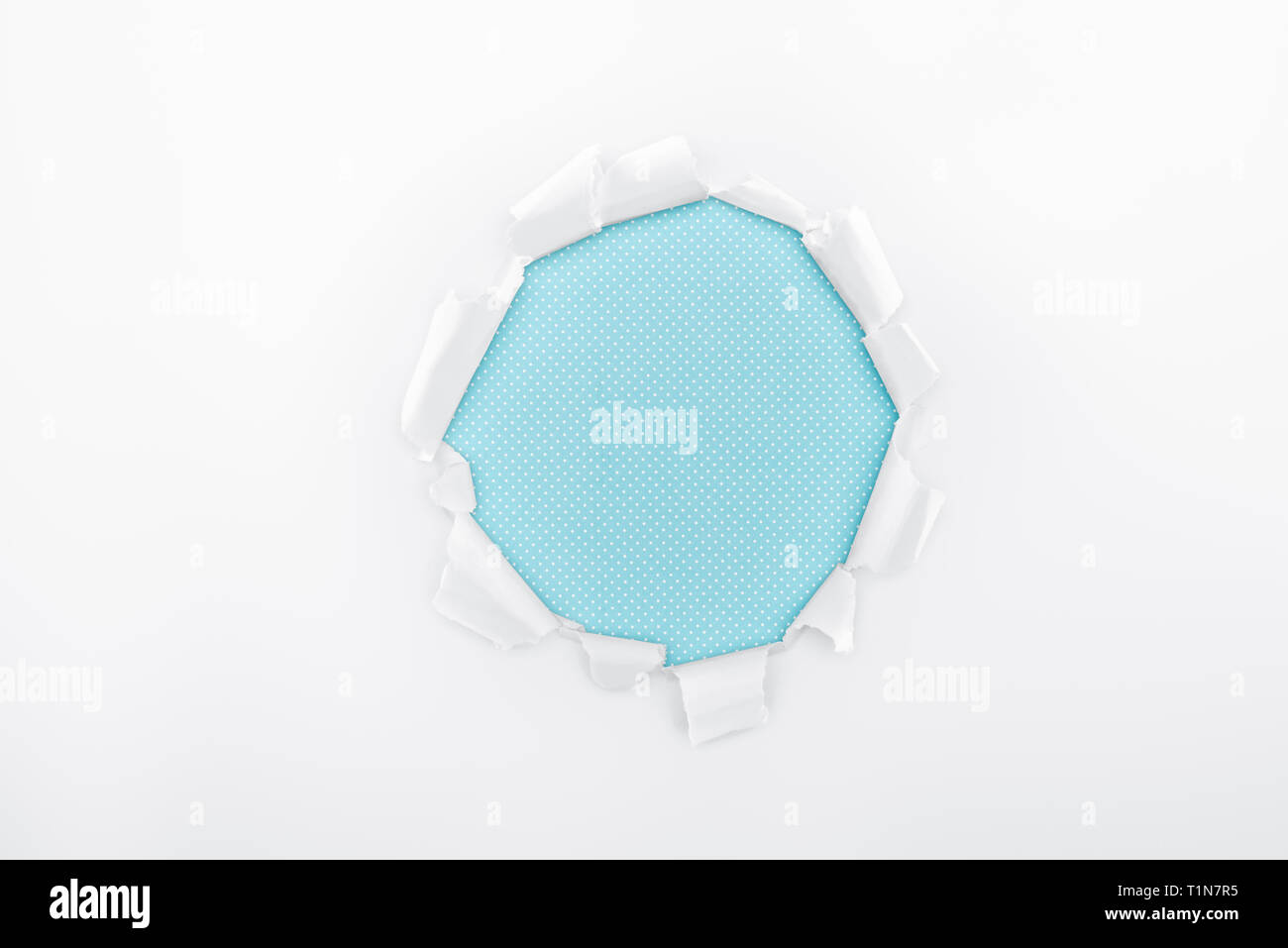 torn hole in textured white paper on light blue background Stock Photo ...