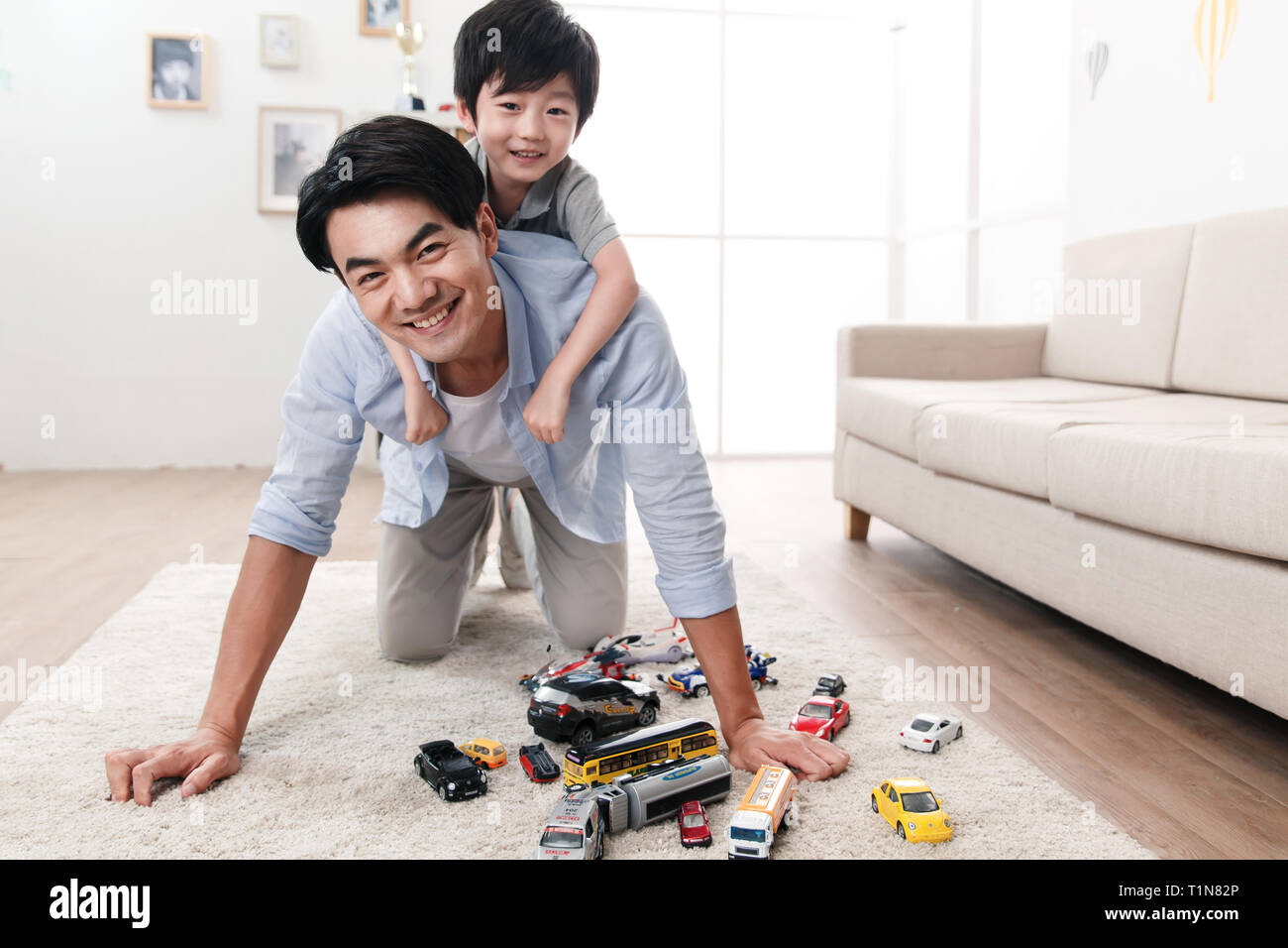 Happy father and son play in the living room Stock Photo - Alamy