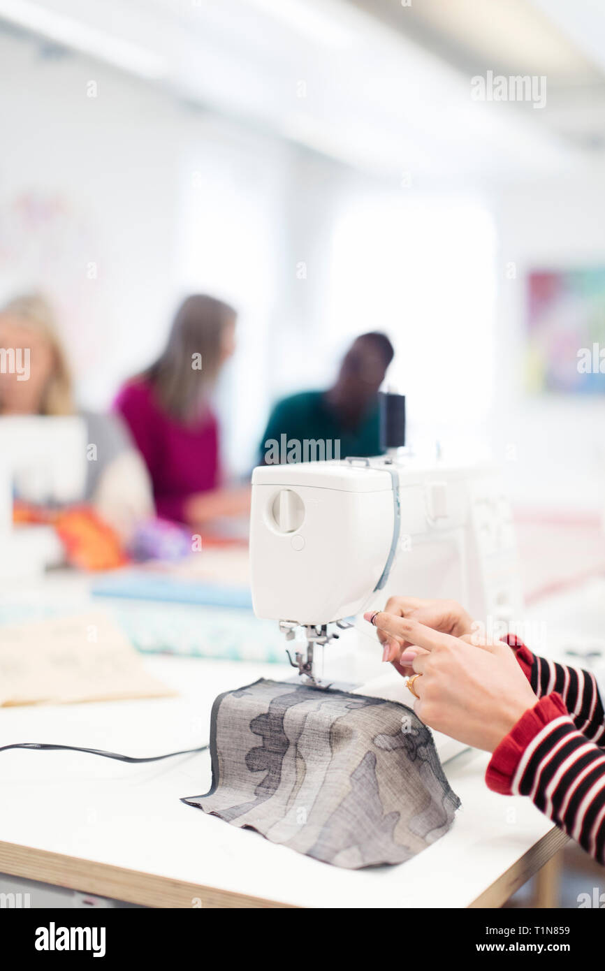Fashion designer using sewing machine Stock Photo - Alamy