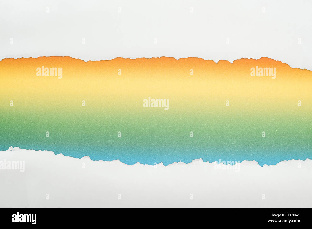 ripped white textured paper with copy space on multicolored background ...