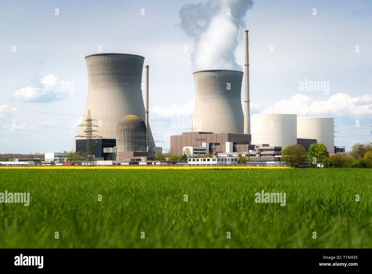 Nuclear power plant with yellow field and big blue clouds Stock Photo ...