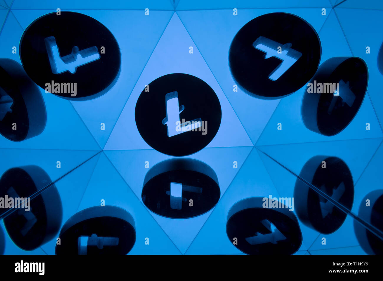 Litecoin Currency Symbol With Many Mirroring Images of Itself on Blue ...