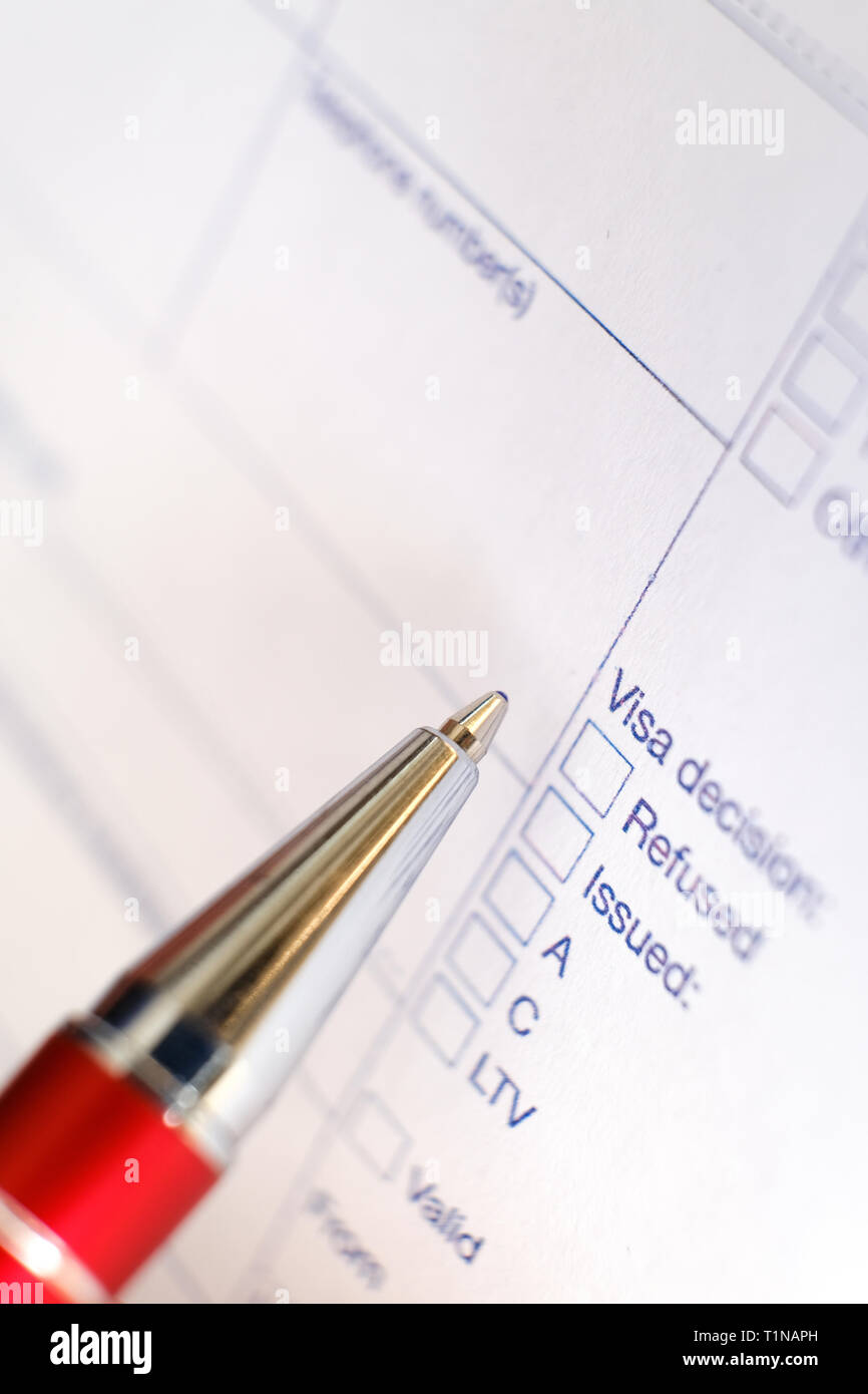 Schengen visa, questionnaire. Hand with pen completing a questionary ...