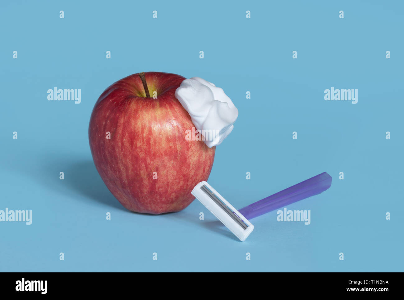apple with shaving foam and disposable razor as a concept for gentle ...