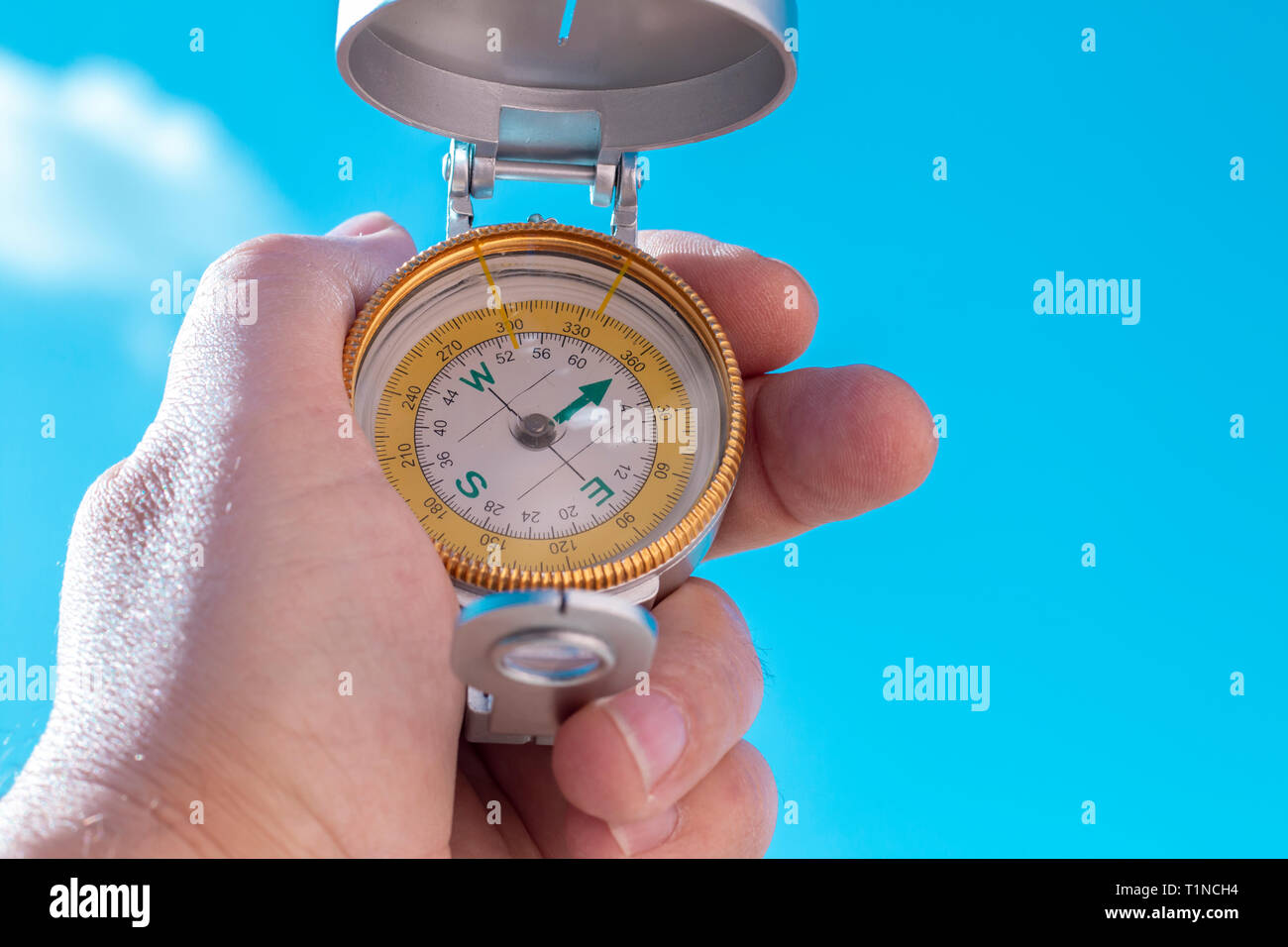 Close up hand holding a compass Stock Photo - Alamy