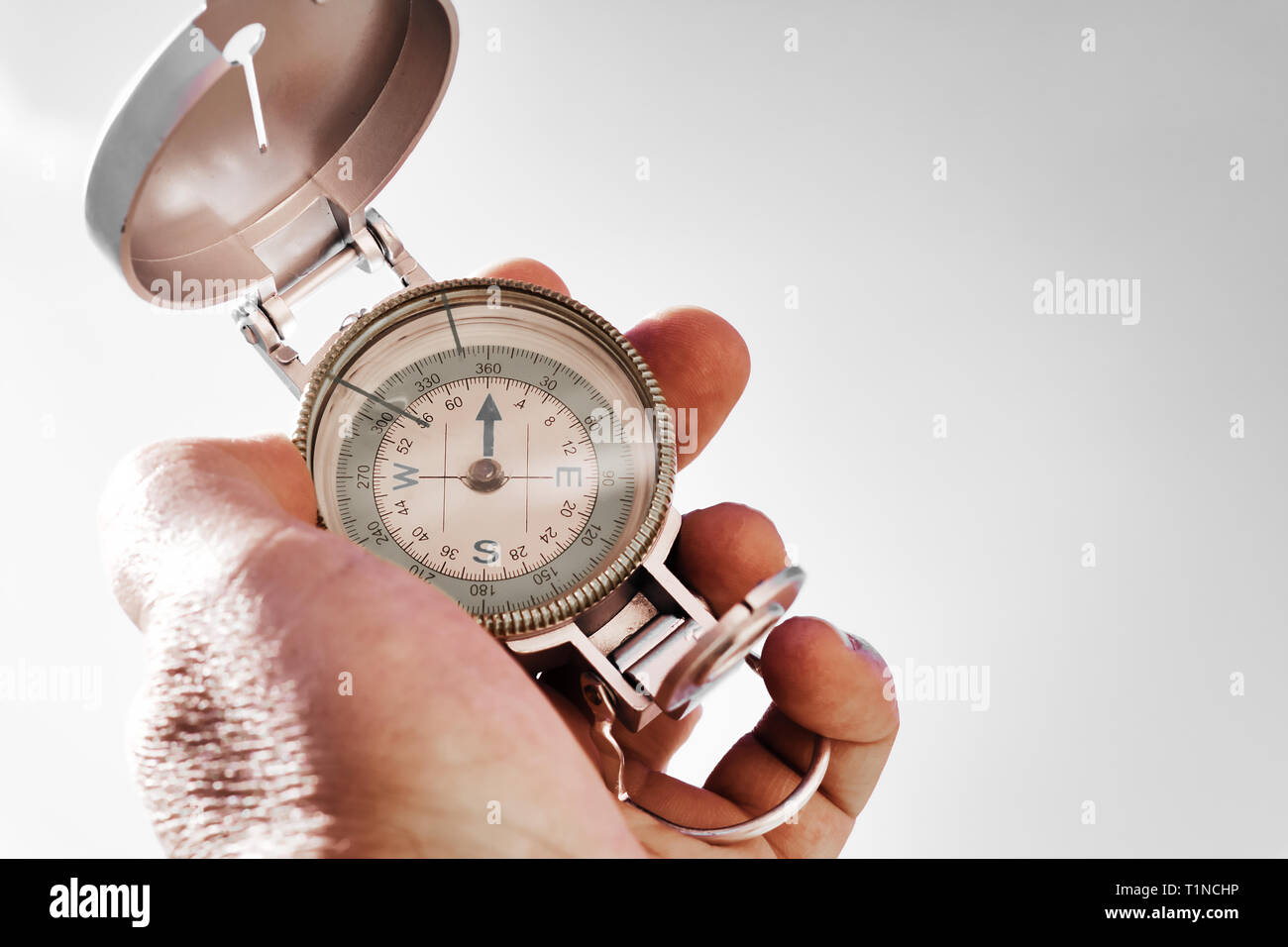 Close up hand holding a compass Stock Photo - Alamy