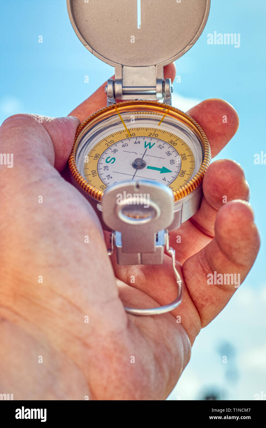 Close up hand holding a compass Stock Photo - Alamy