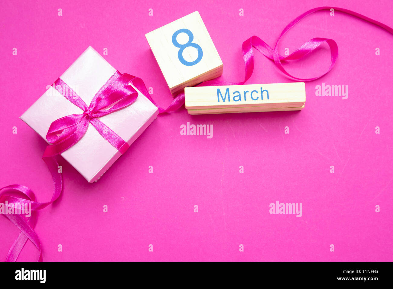 Womens day concept. Gift box with ribbon and date March 8th on wooden ...