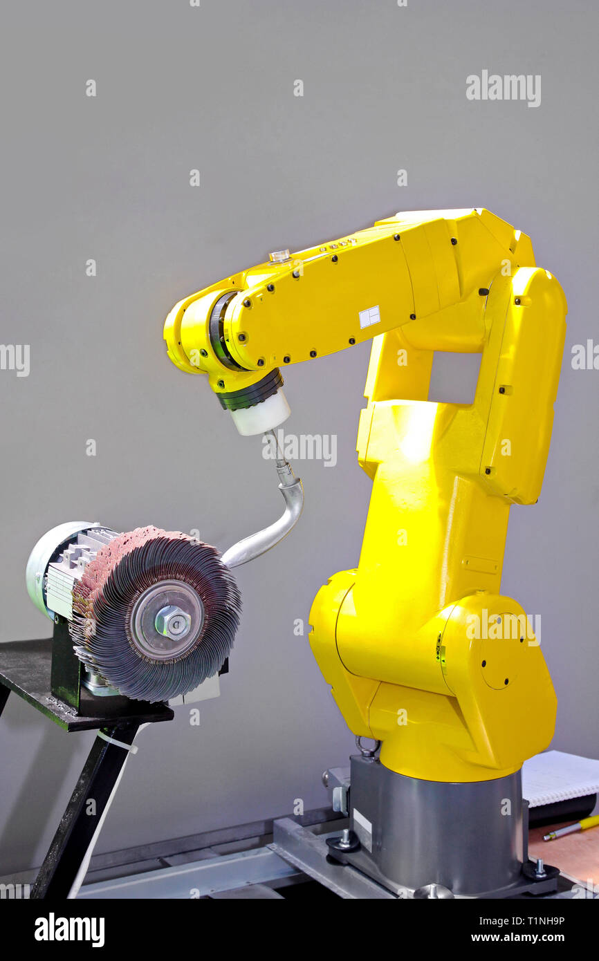 Yellow robotic arm for automatic operations in factory Stock Photo - Alamy