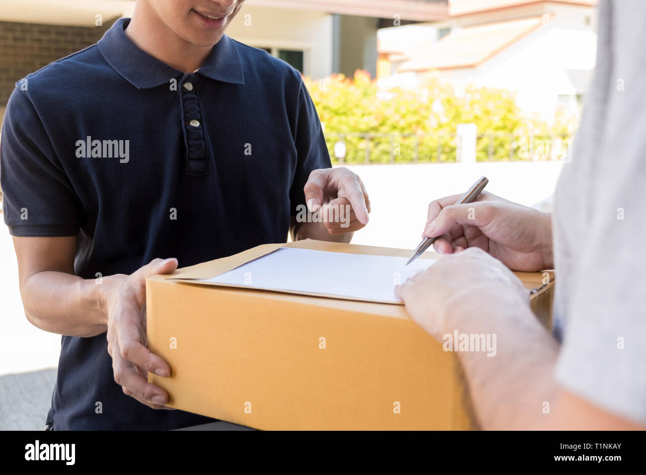 delivery service concept, customer hand receiving a cardboard boxes ...