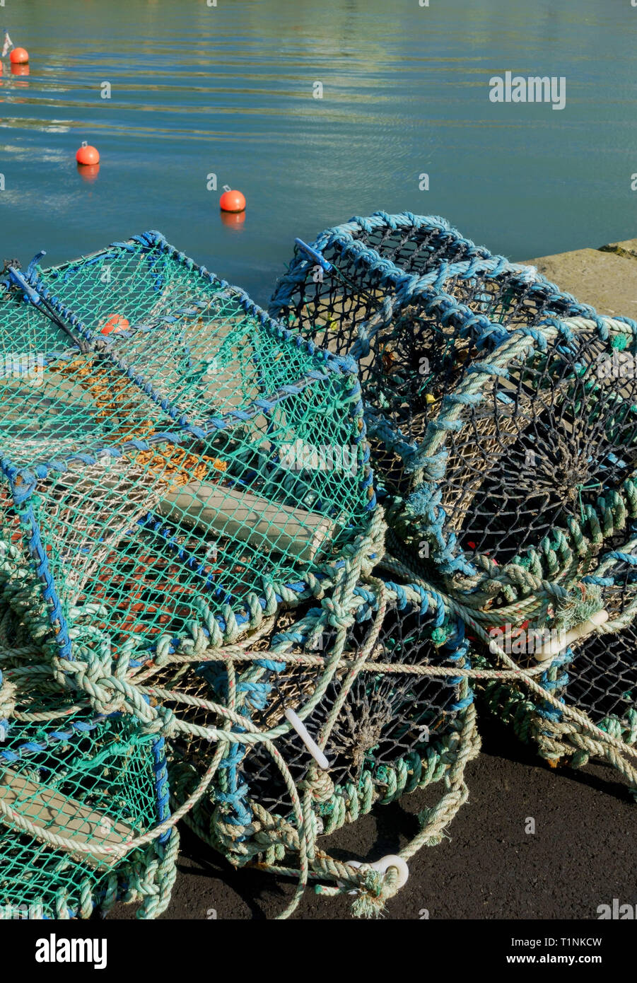 A stack of lobster and crab pots on the harbour at Portpatrick ...
