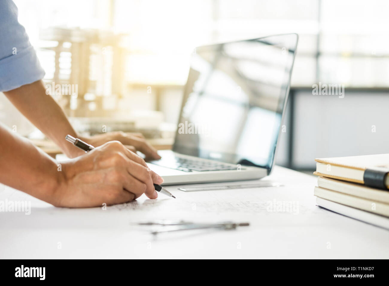 Person's engineer Hand Drawing Plan On Blue Print with architect ...