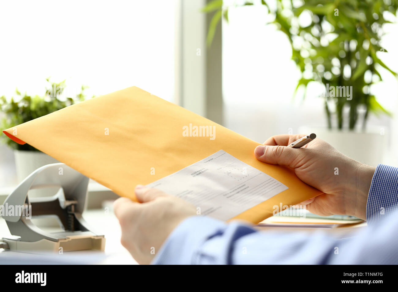 Businessman hold hand yellow mail envelope Stock Photo - Alamy