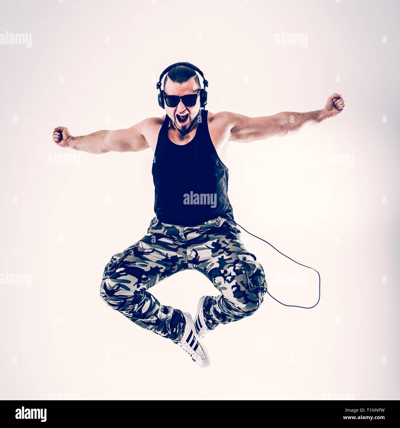 emotional and charismatic DJ - rapper with headphones on a white Stock ...